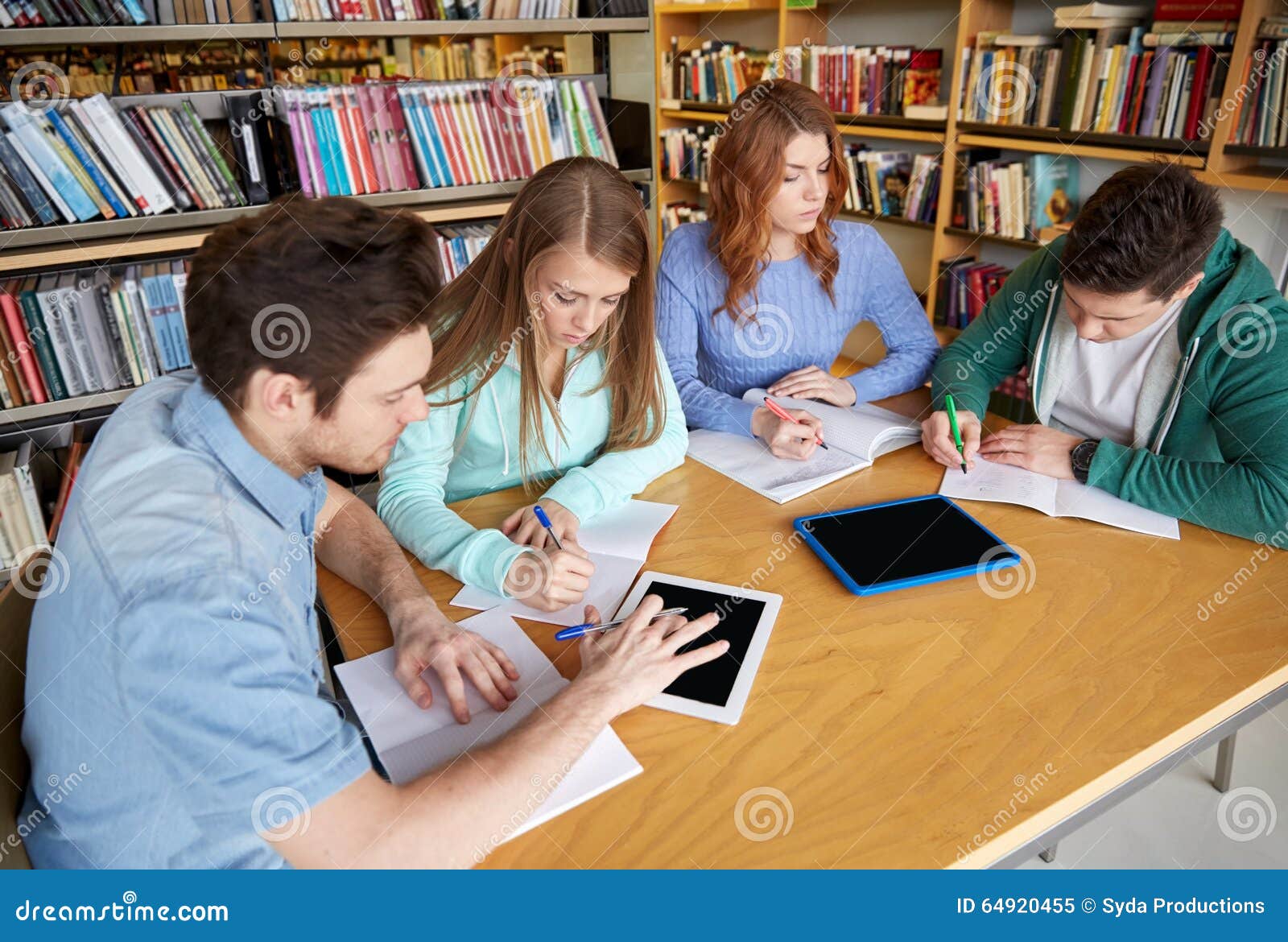 Students Writing To Notebooks in Library Stock Image - Image of ...