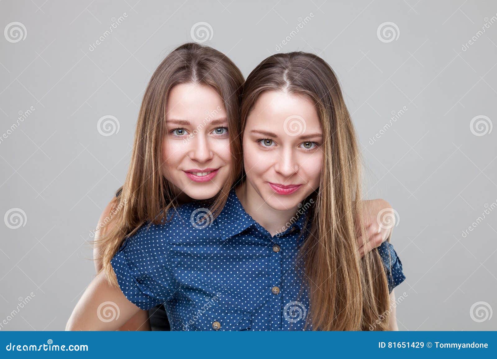 Studio Portait of Young Twin Sisters Embracing Stock Image - Image of ...