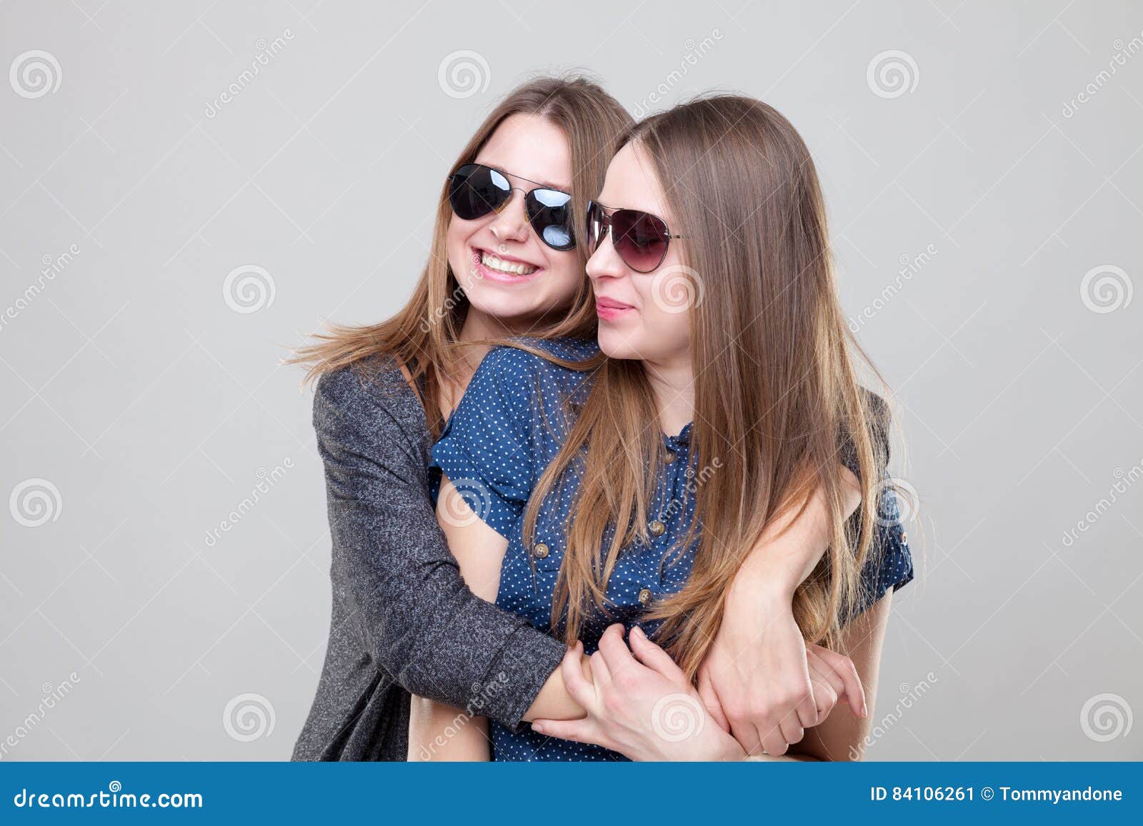 Studio Portait of Young Twin Sisters Embracing Stock Image - Image of ...