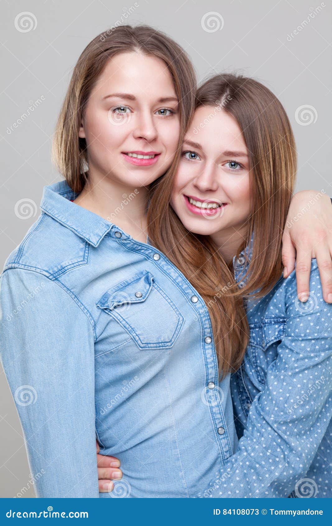 Studio Portait of Young Twin Sisters Embracing Stock Image - Image of ...