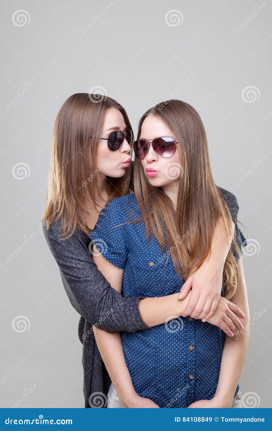 Studio Portait of Young Twin Sisters Embracing Stock Image - Image of ...