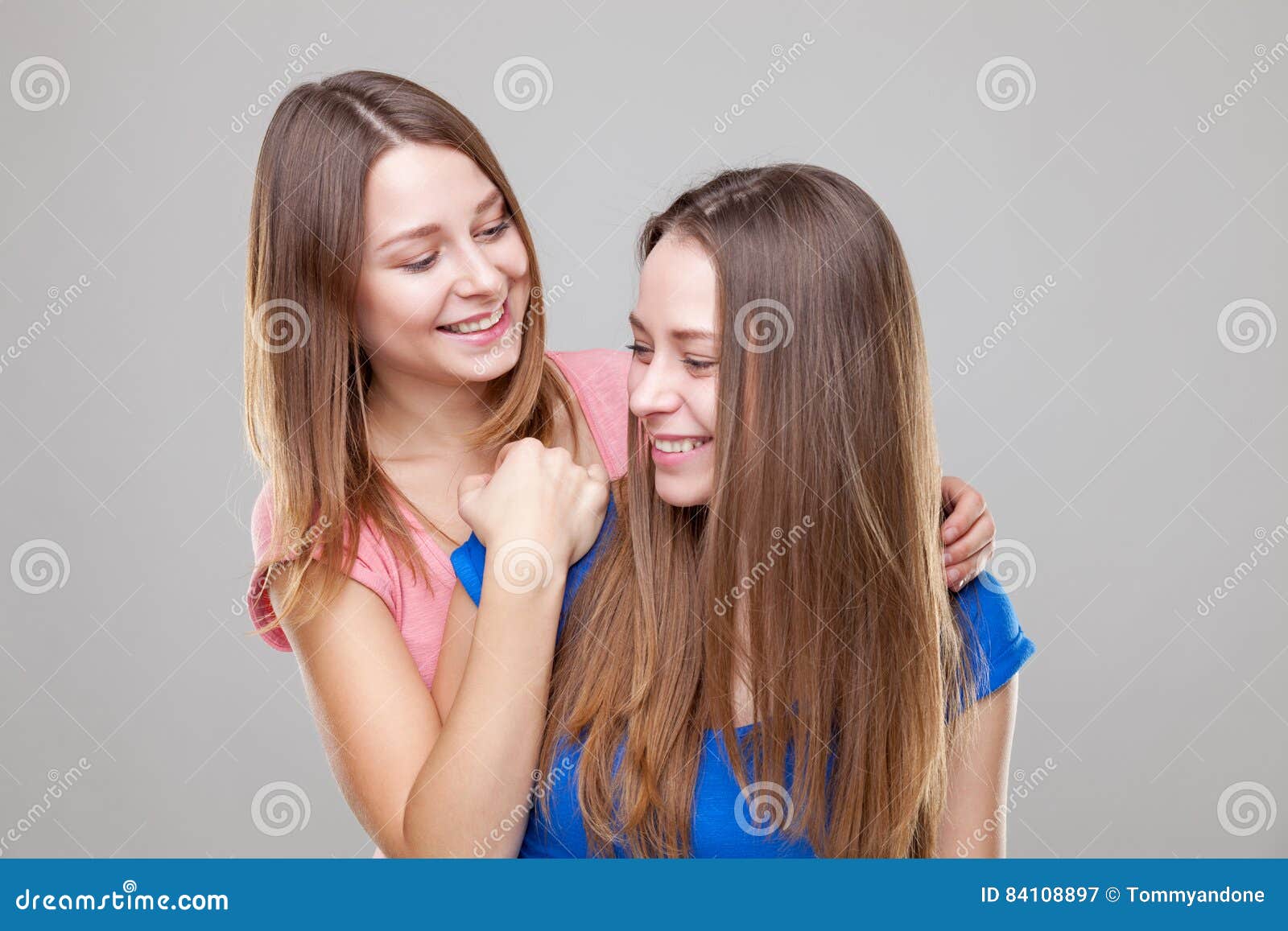 Studio Portait of Young Twin Sisters Embracing Stock Image - Image of ...