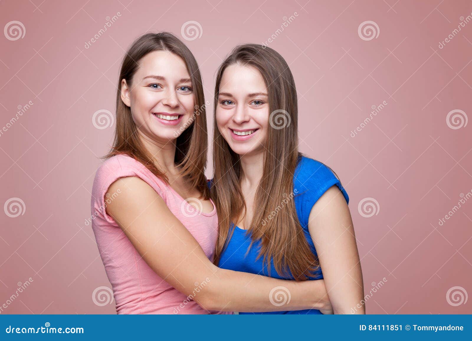 Studio Portait of Young Twin Sisters Embracing Stock Image - Image of ...