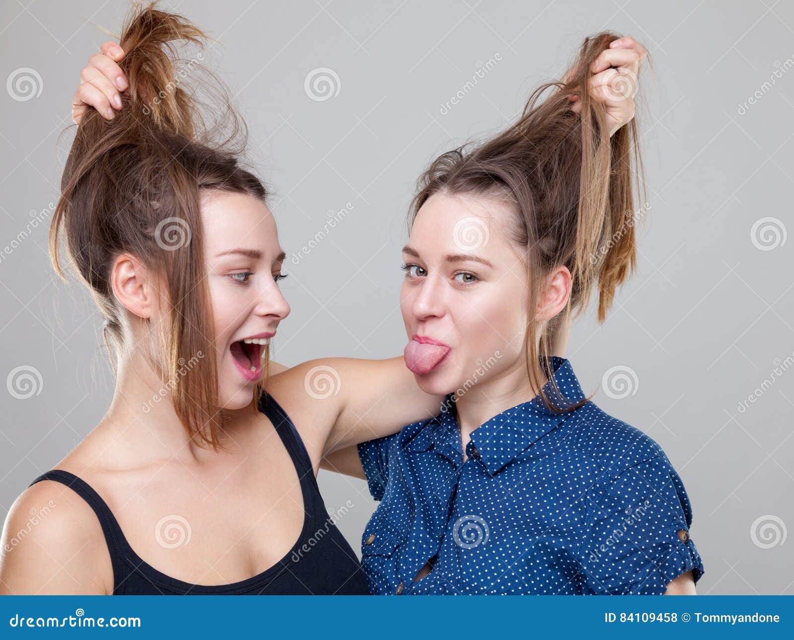 Studio Portait of Young Twin Sisters Fighting Stock Photo - Image of ...