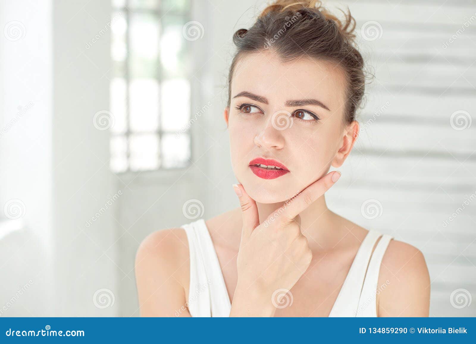 Studio Portrait of Beautiful Young Woman Thinking and Looking Upwards ...