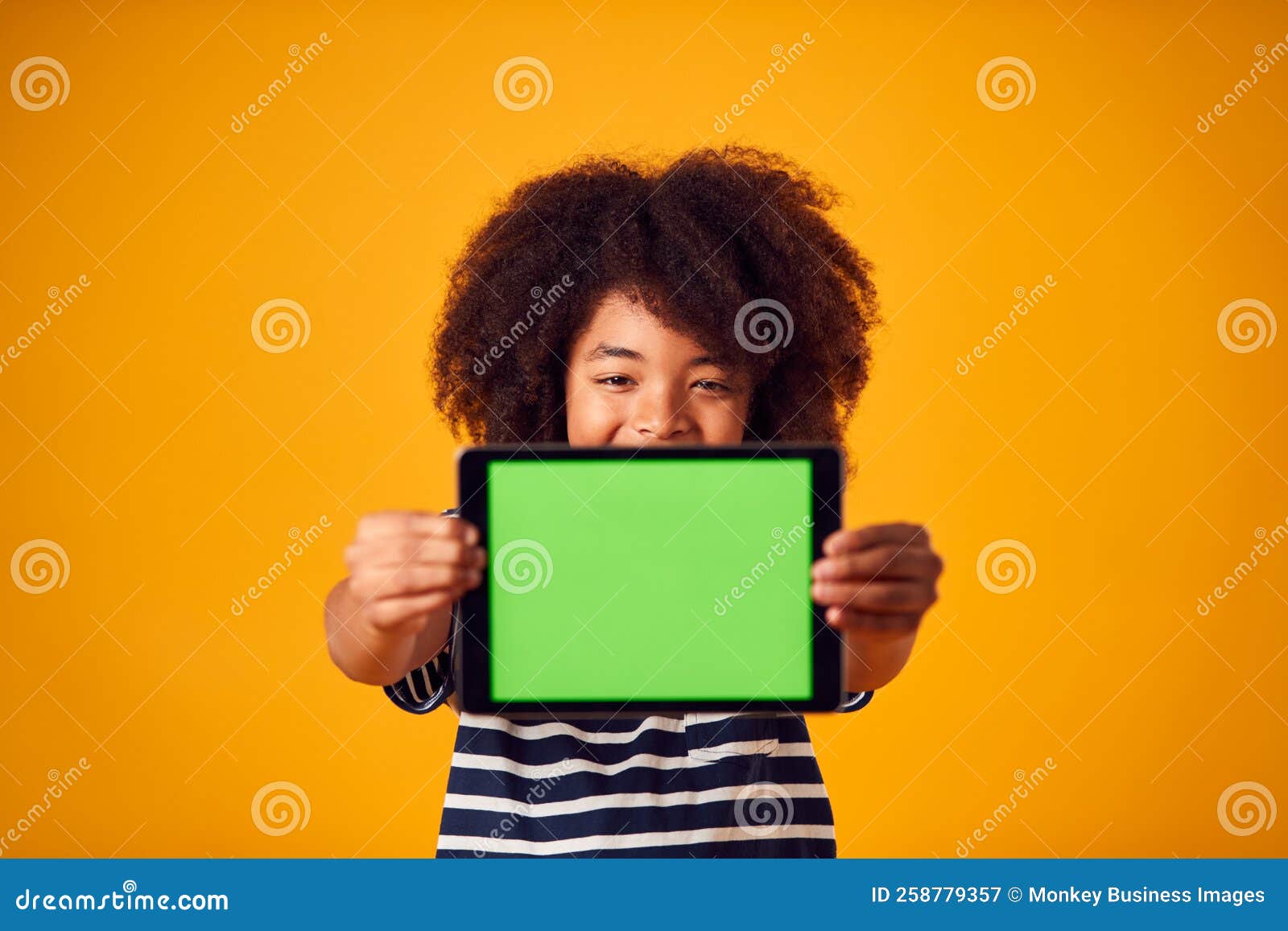 Studio Portrait of Boy Using Digital Tablet with Green Screen Against ...