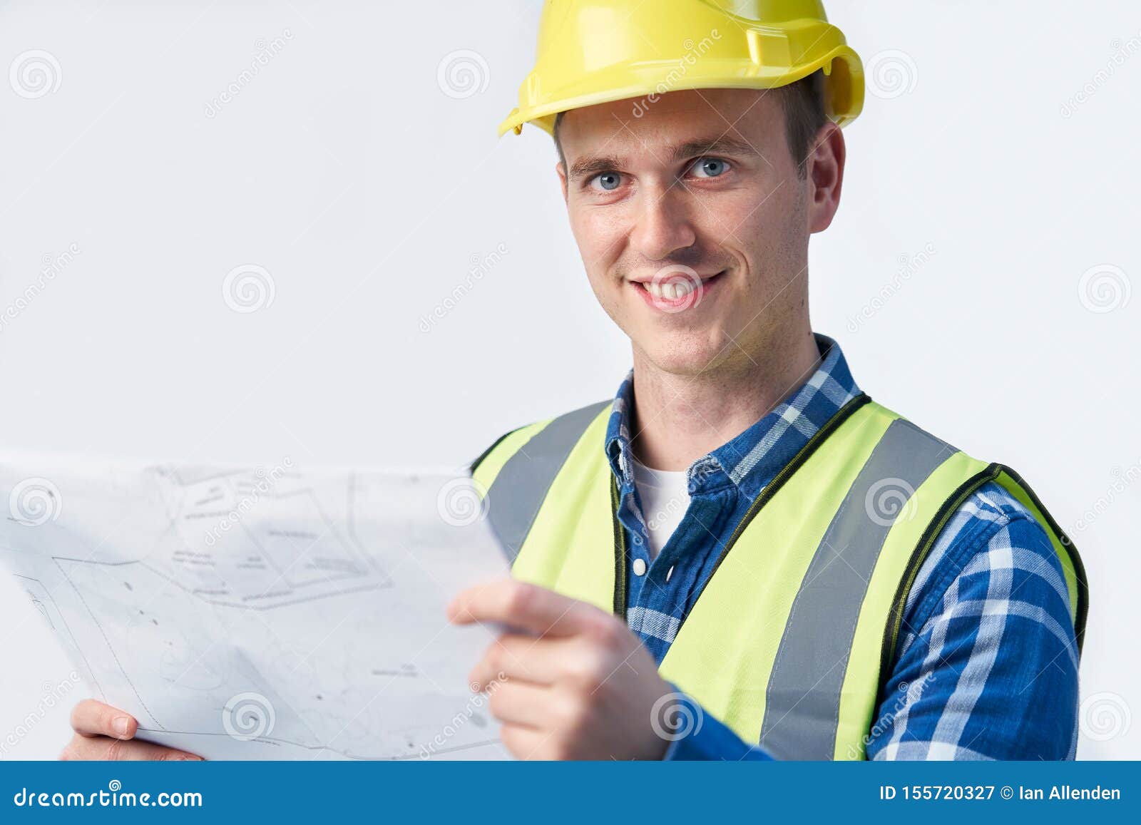 Studio Portrait of Builder Architect Looking at Plans Against White ...