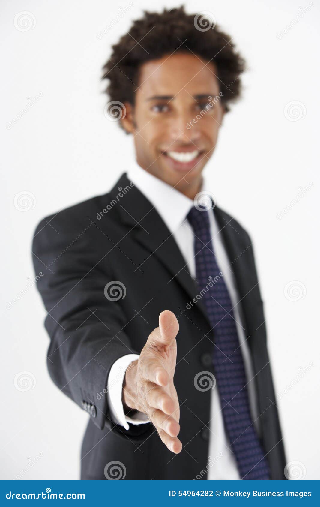 Studio Portrait of Businessman Reaching Out To Shake Hands Stock Photo ...