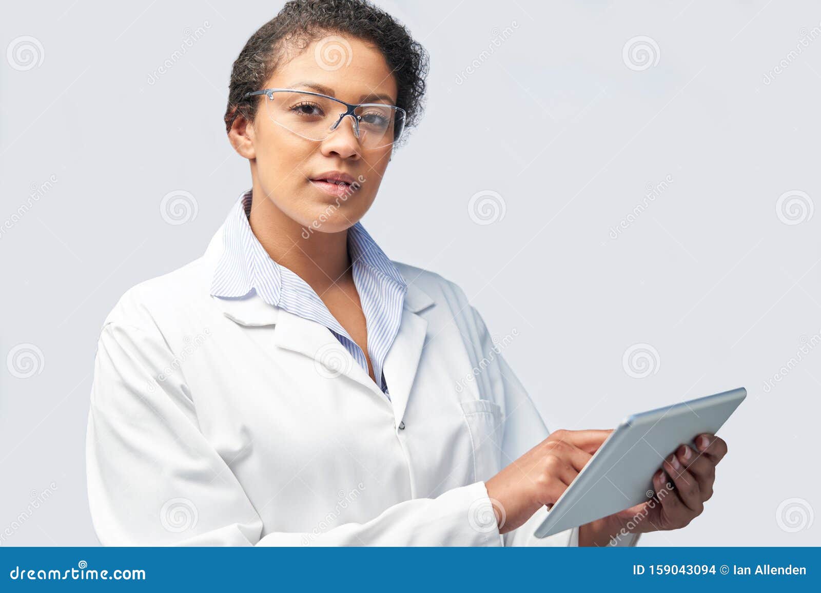 Studio Portrait of Female Laboratory Technician Working with Digital ...