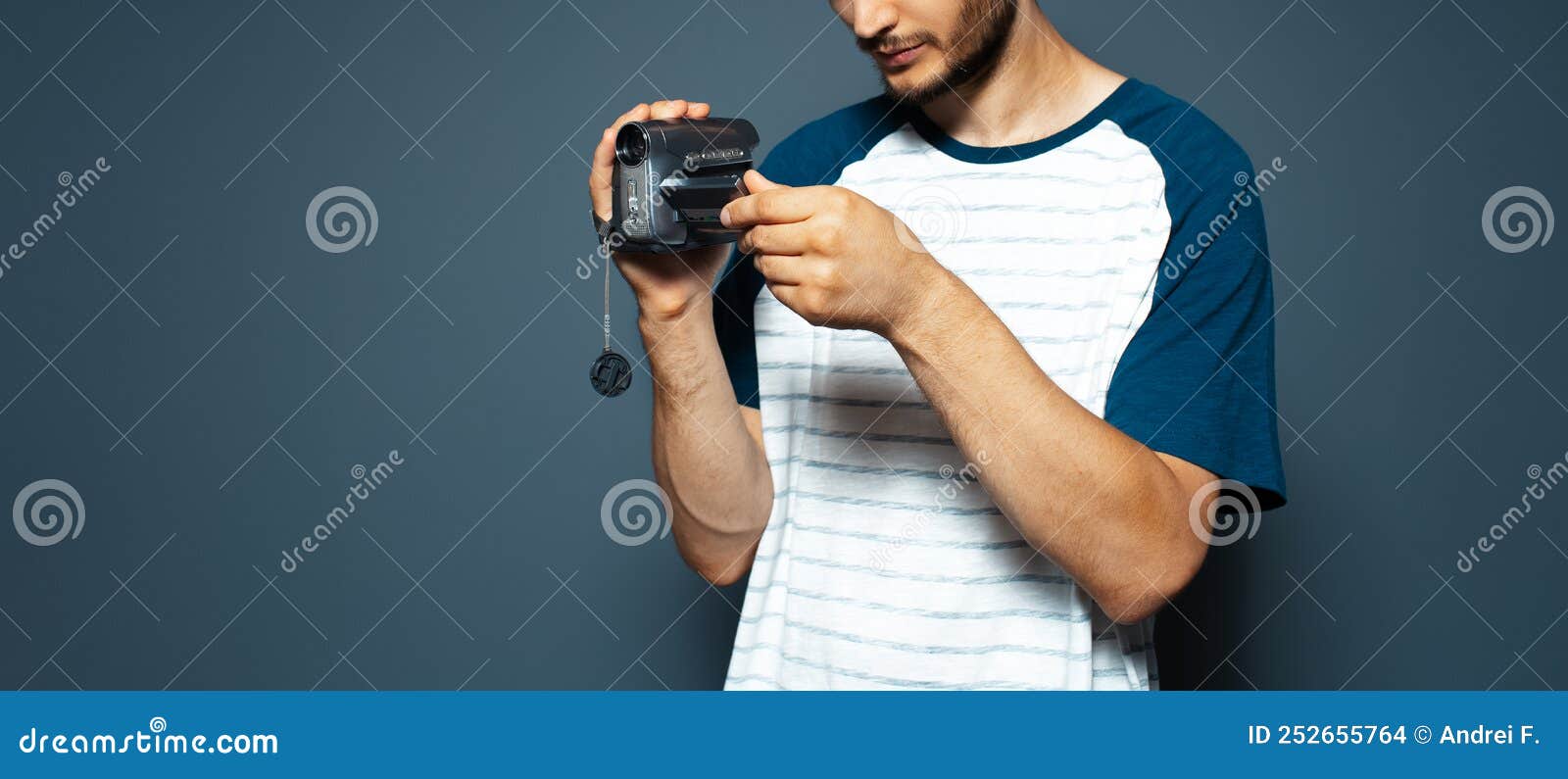 Studio Portrait of Guy with Digital Video Camera in Hands. Panoramic ...