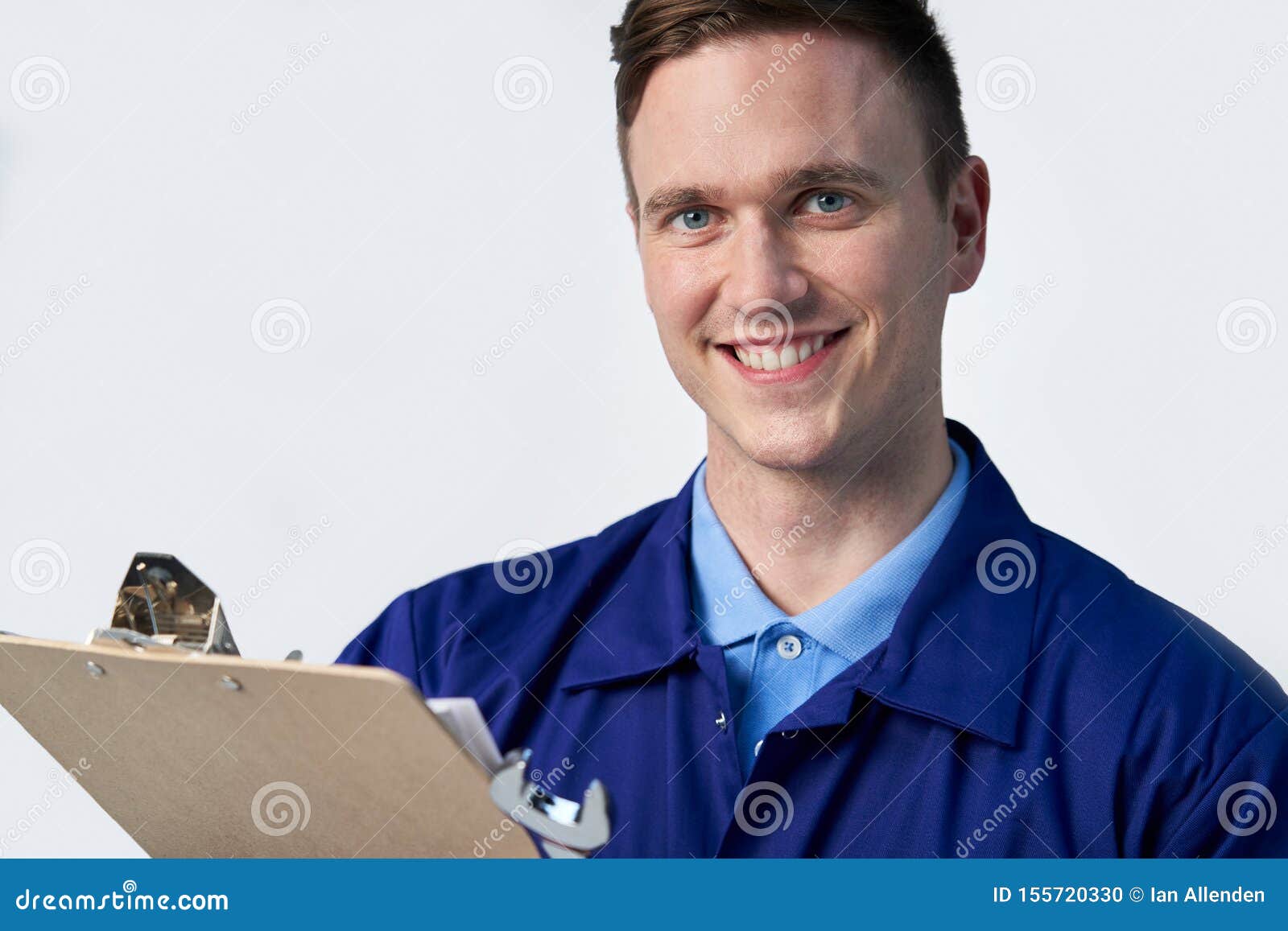 Studio Portrait of Male Engineer with Clipboard and Spanner Against ...