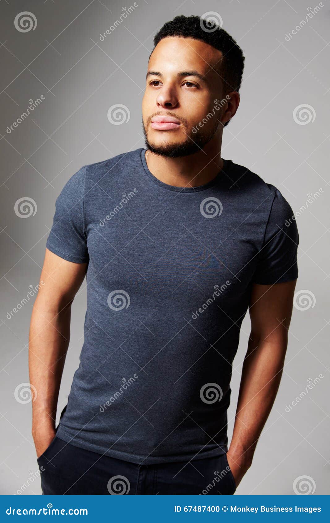 Studio Portrait of Man Standing Against Grey Background Stock Photo ...
