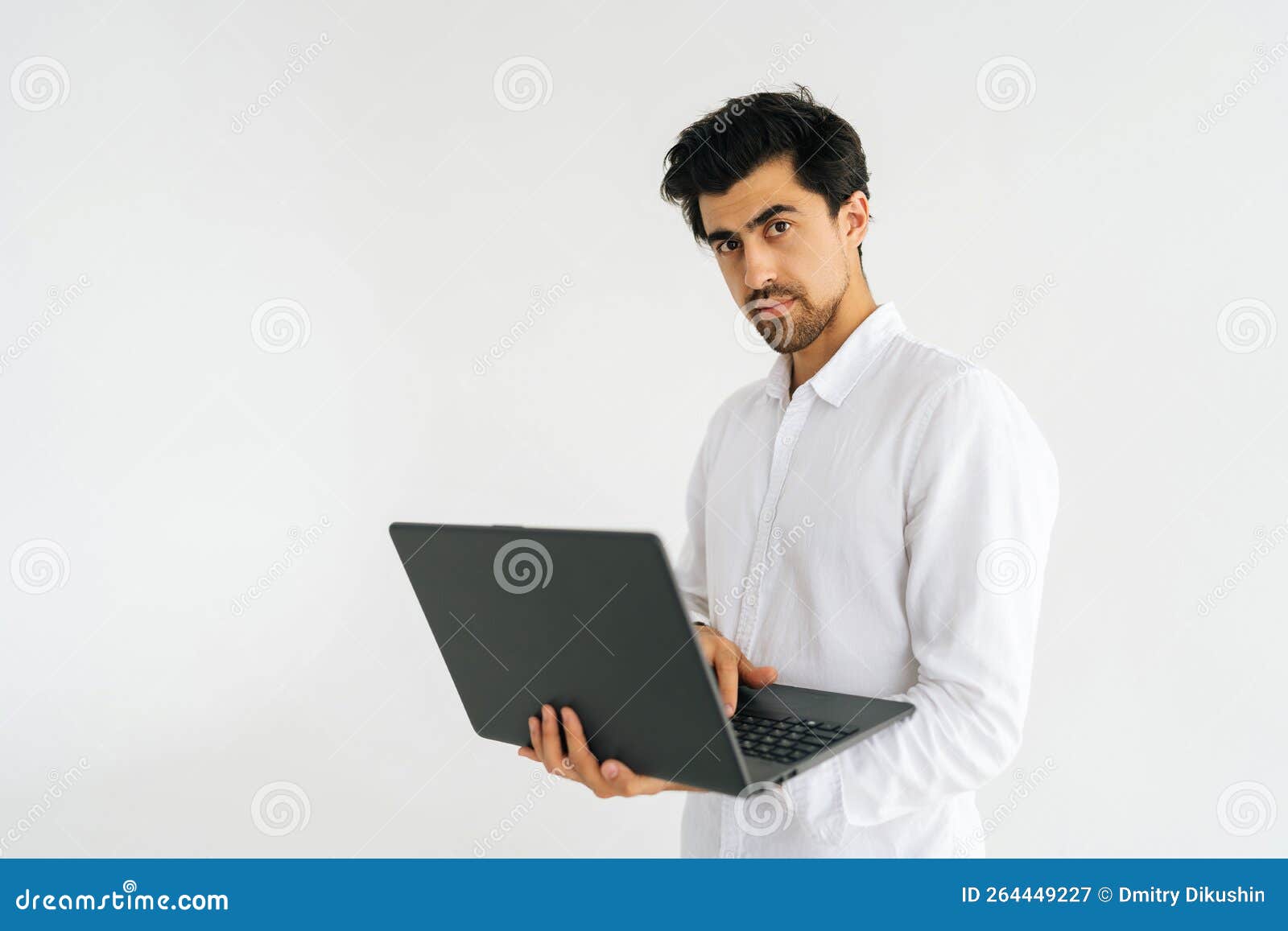 Studio Portrait of Serious Confident Young Man Holding in Hand Opened ...