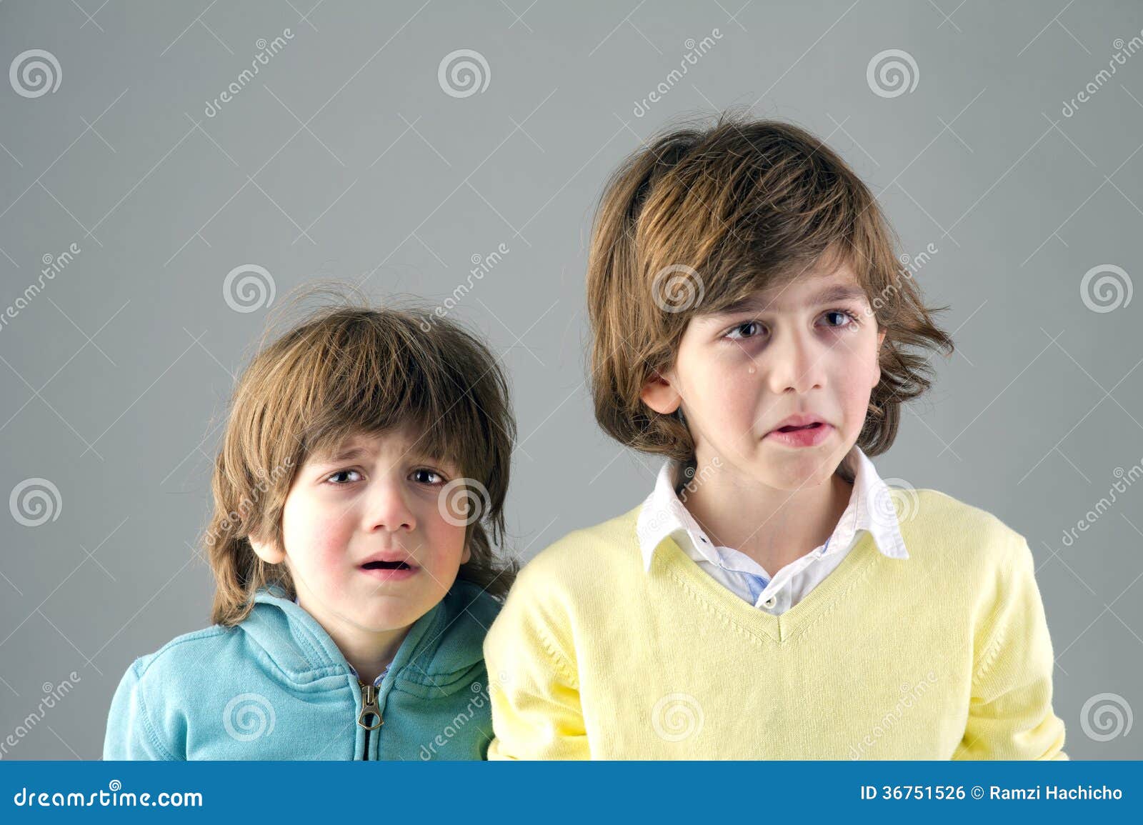 Studio Portrait of Two Young Brothers Feeling Worried Stock Photo ...