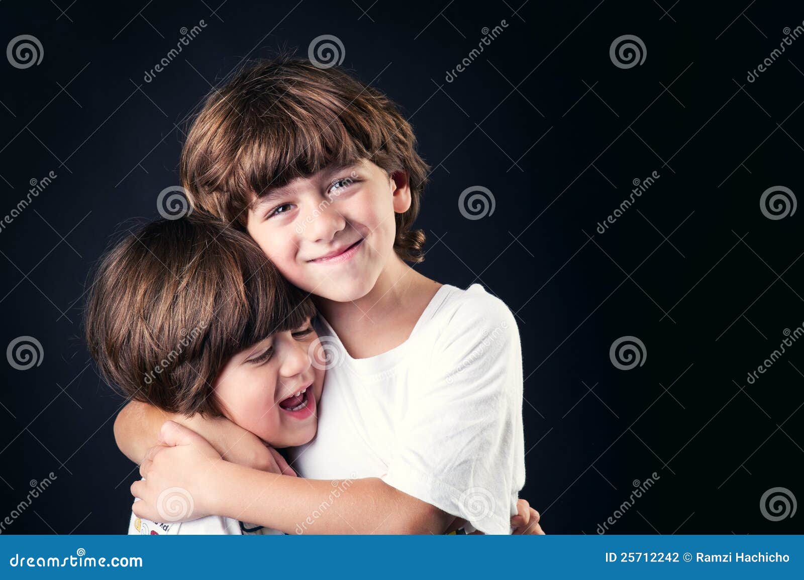 Studio Portrait of Two Young Brothers Hugging and Smiling Stock Photo ...