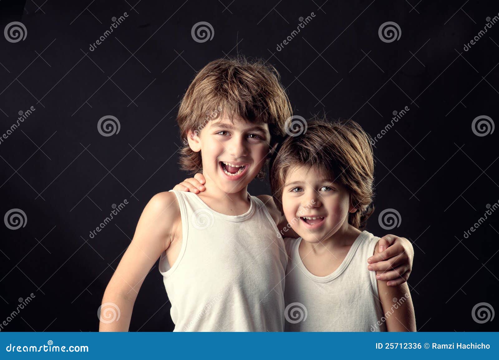 Studio Portrait of Two Young Brothers Hugging and Smiling Stock Photo ...