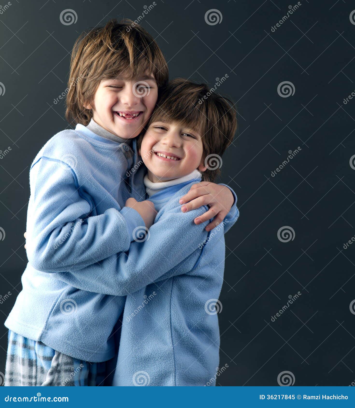 Studio Portrait of Two Young Brothers Hugging and Smiling Stock Image ...