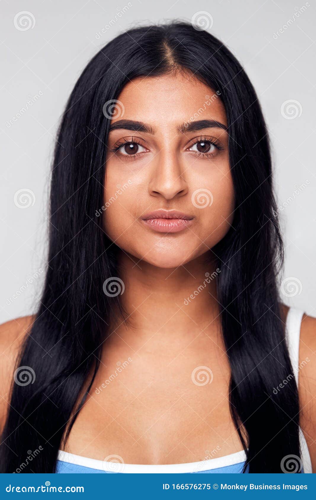 Studio Portrait of Woman with Serious Expression Looking at Camera ...