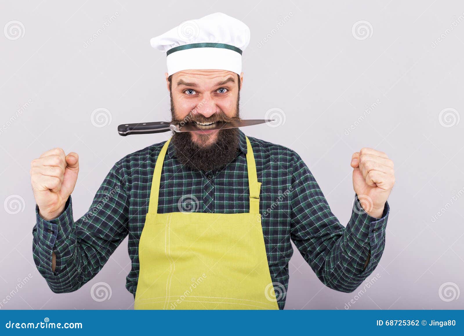 Studio Shot of a Bearded Man Holding a Sharp Knife with His Teeth Stock ...