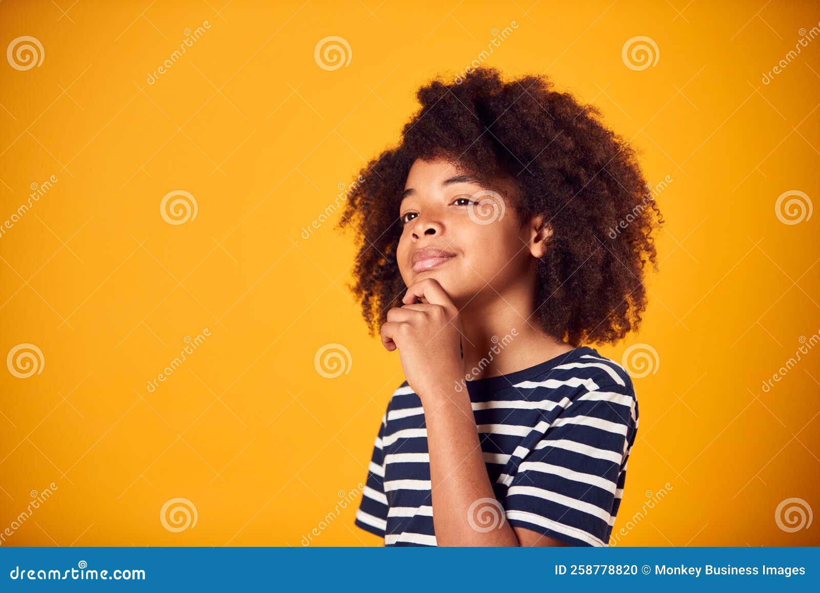 Studio Shot of Boy with Puzzled Expression Thinking Against Yellow ...
