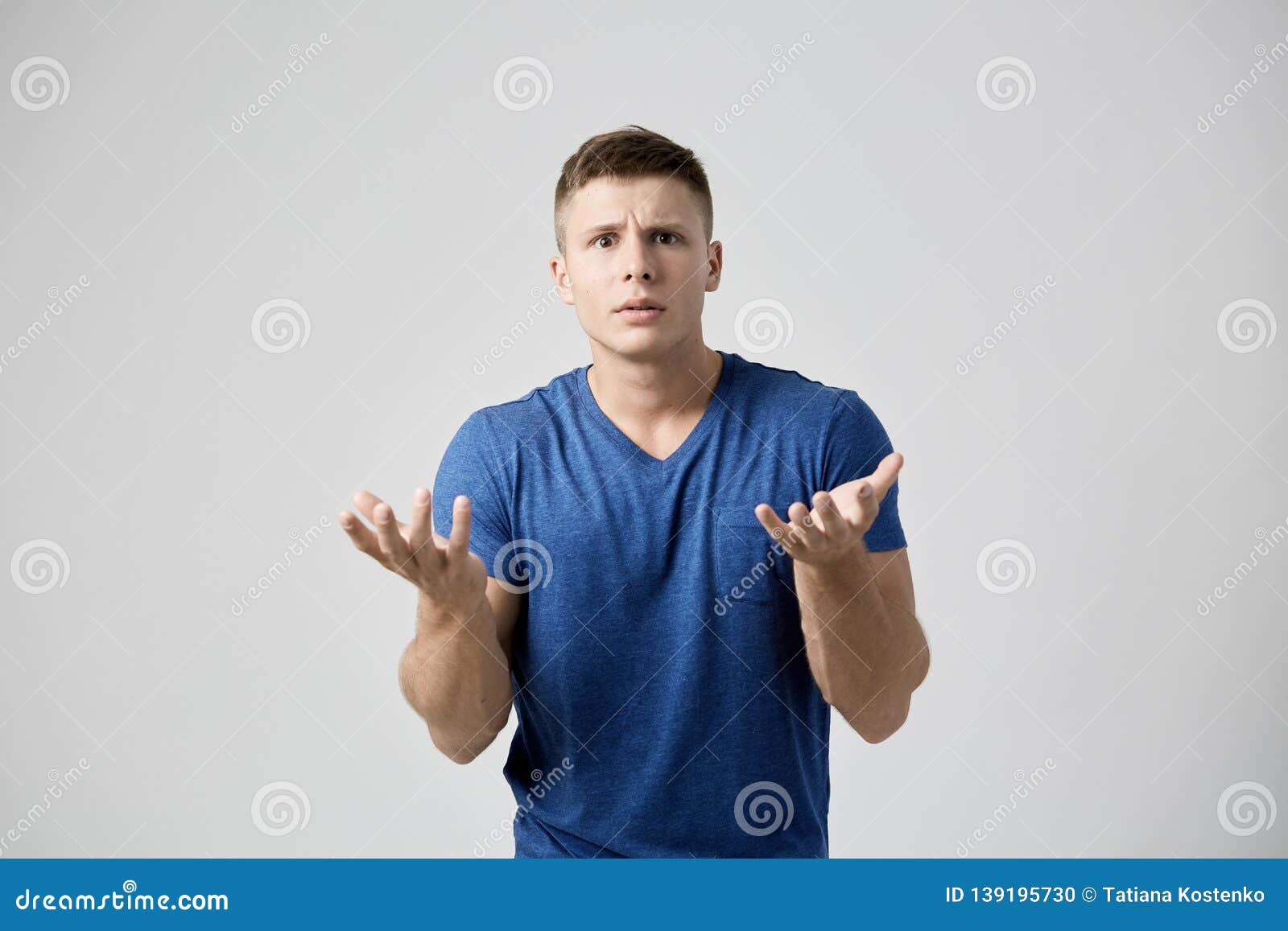 Studio Shot of the Guy Dressed in Blue T-shirt Feels Bewildered and ...
