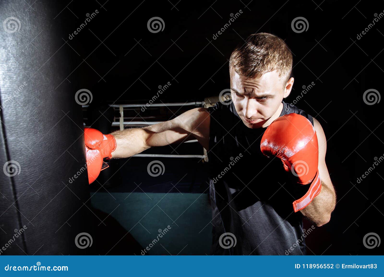 Studio Shot of Male Boxer Punching a Boxing Bag. Stock Photo - Image of ...