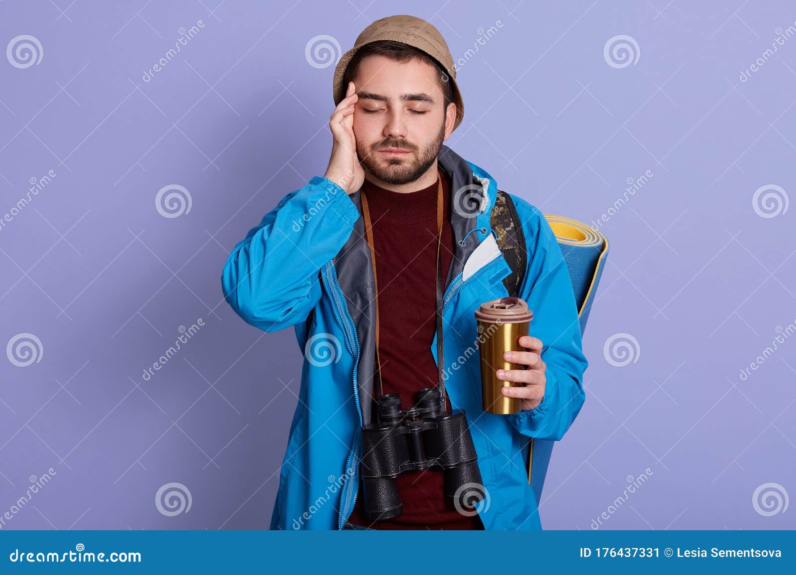 Studio Shot of Man with Backpack Against Lilac Background, Holding ...