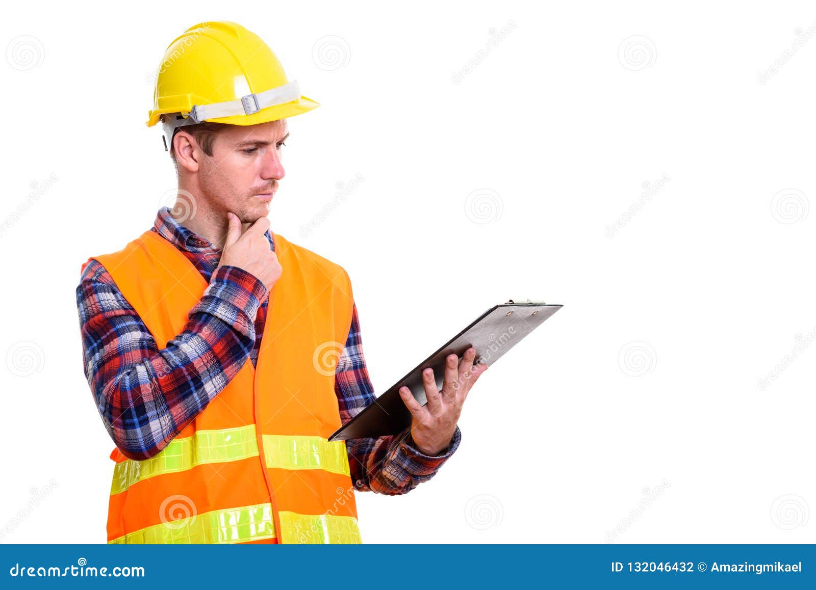 Studio Shot of Man Construction Worker Reading on Clipboard Whil Stock ...