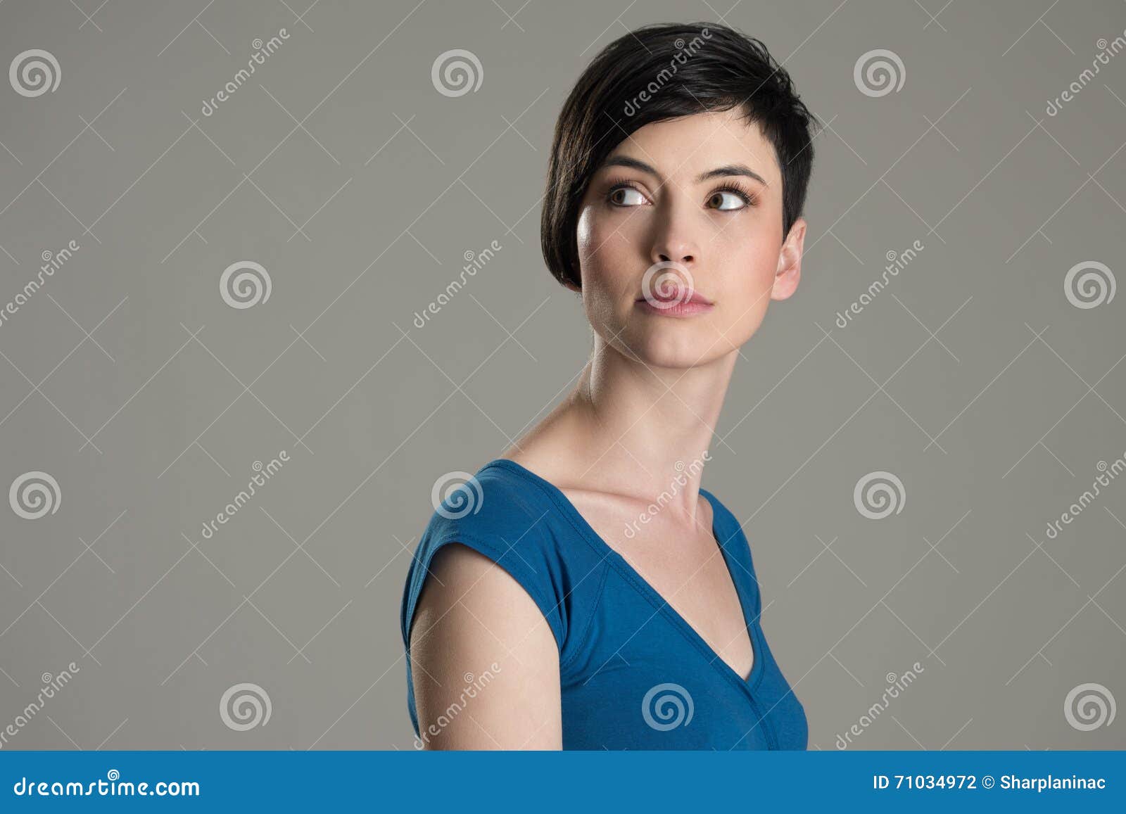 Studio Shot of Short Hair Beauty Model Looking Back Over the Shoulder ...