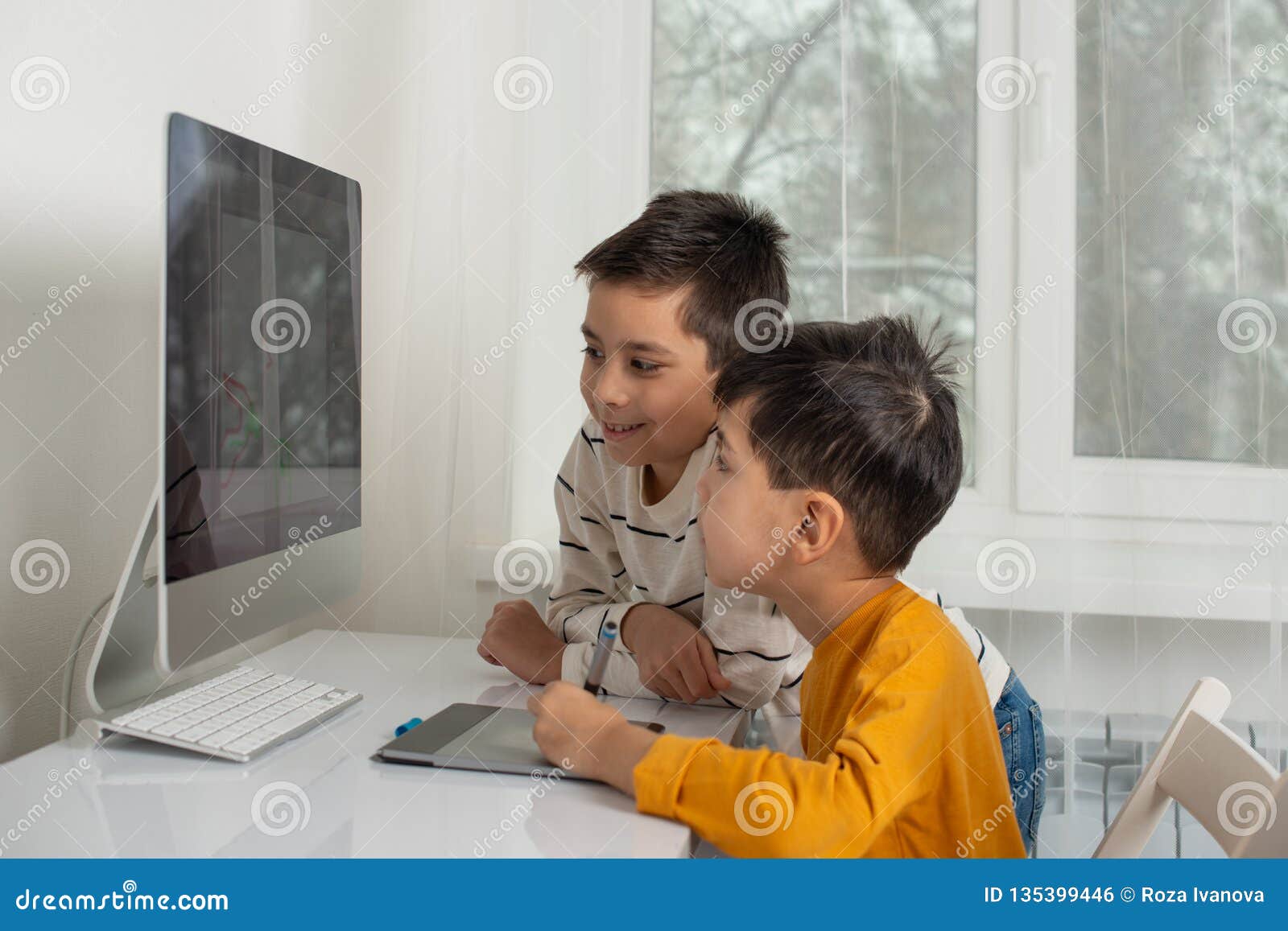 Boys Enthusiastically Draw on a Computer Using a Tablet Stock Photo ...