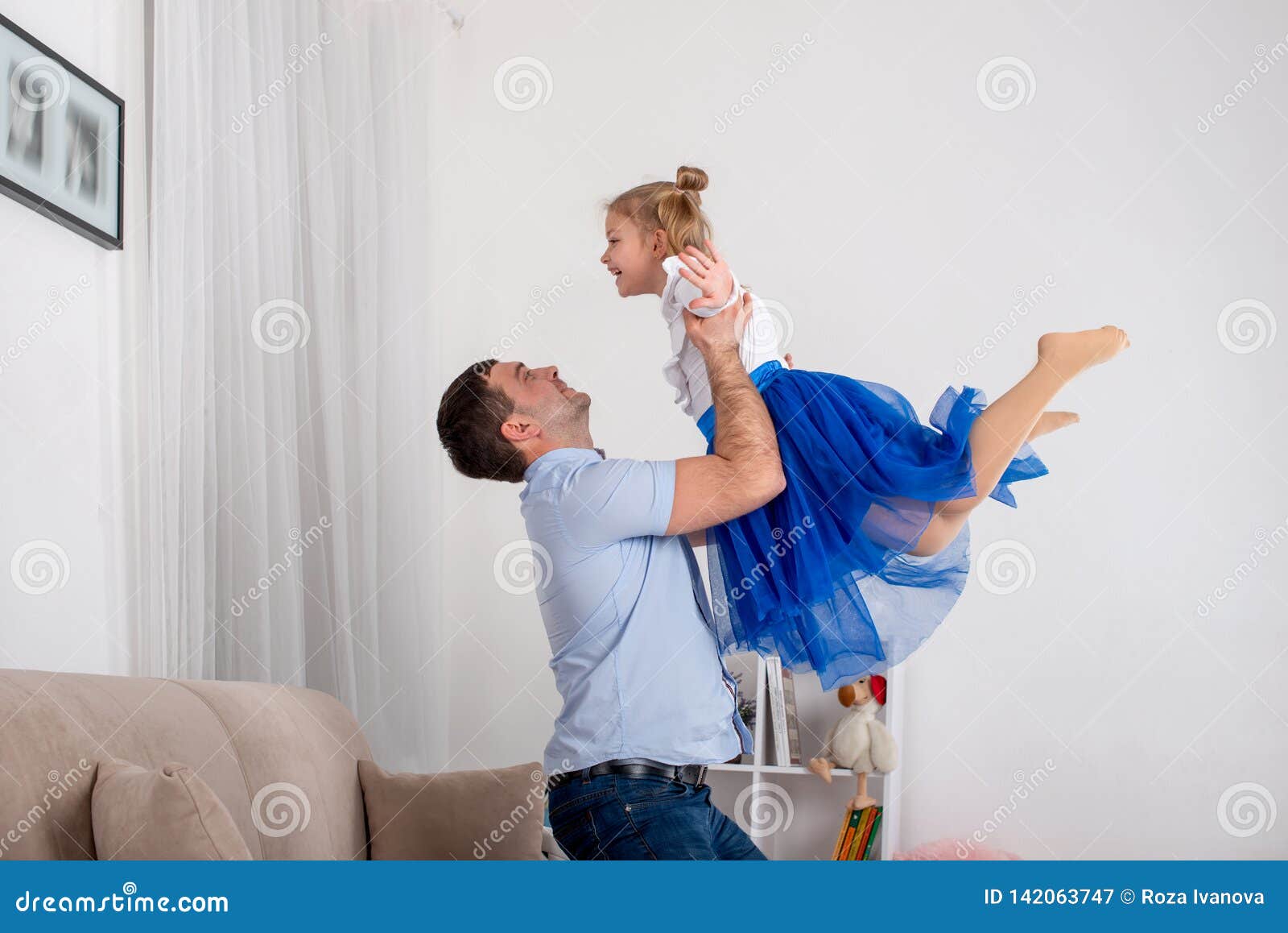 Studio Shot of a Father Lovingly Lifting the Little Daughter Up Stock ...