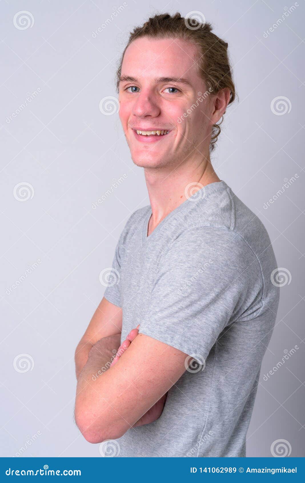 Profile View Of Happy Young Handsome Man Smiling And Looking At Camera