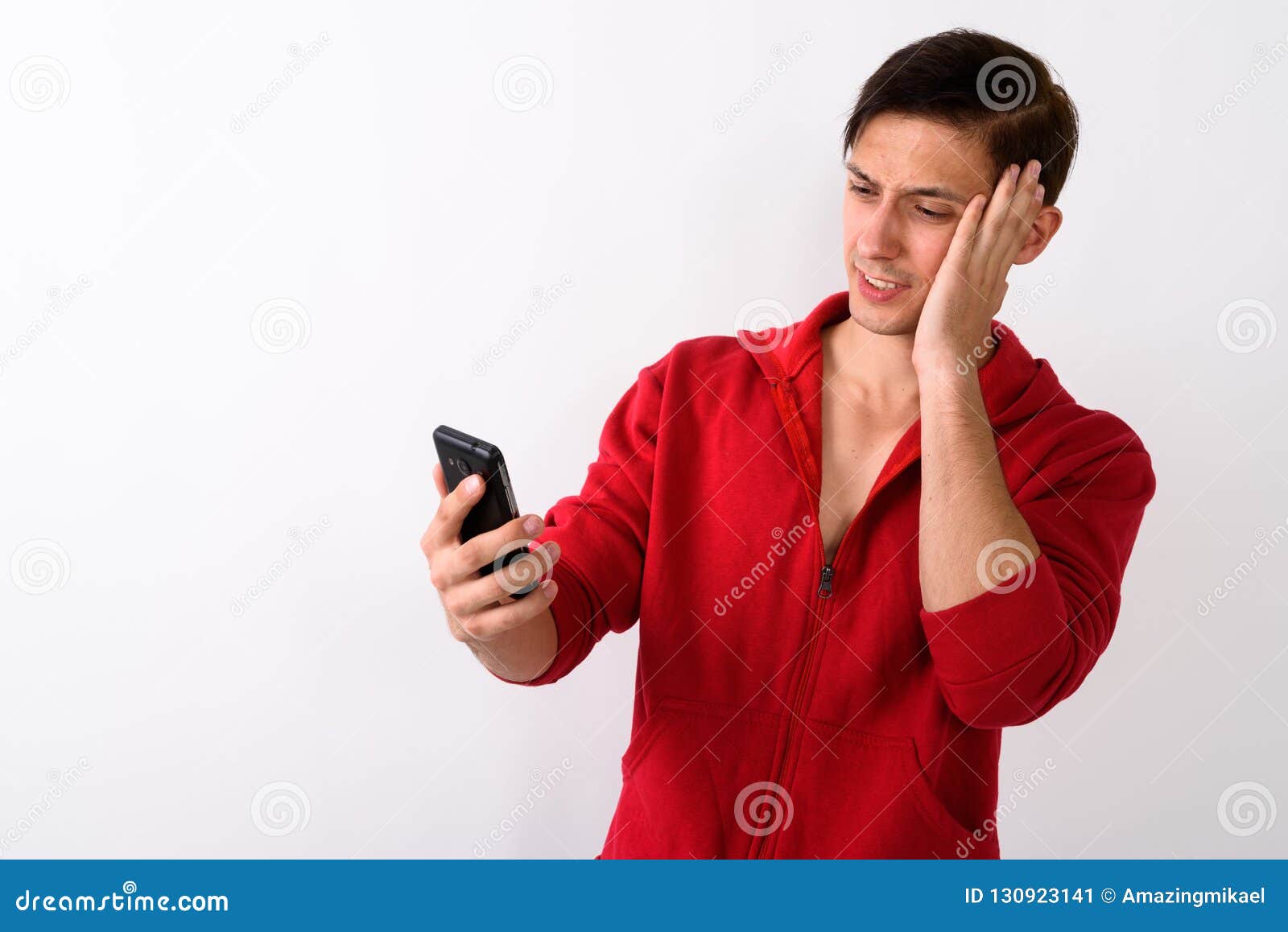 Studio Shot Of Young Handsome Man Having Headache While Using Mo Stock ...