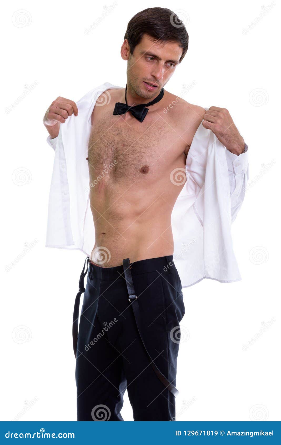 Studio Shot of Young Handsome Man Opening Shirt and Thinking Whi Stock ... Studio Shot of Young Handsome Man Opening Shirt and Thinking Whi Stock ...