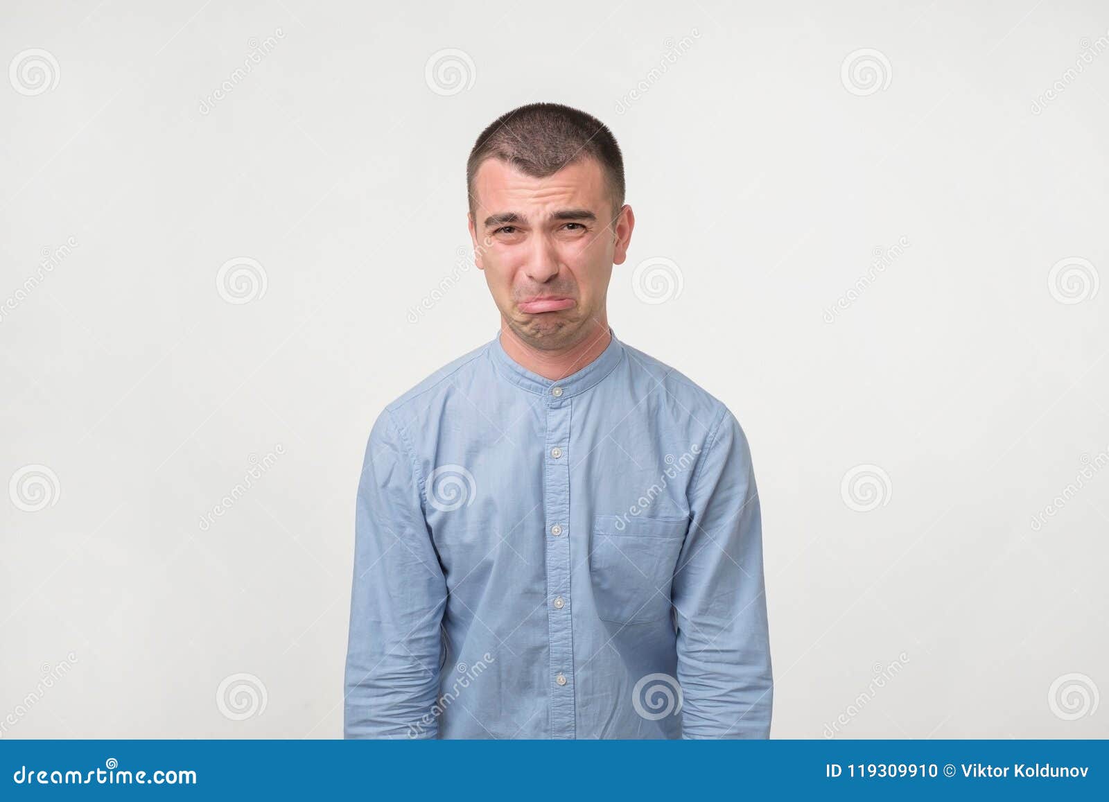 Studio Shot of Young Handsome Man, Pouting and Crying, Complaining ...