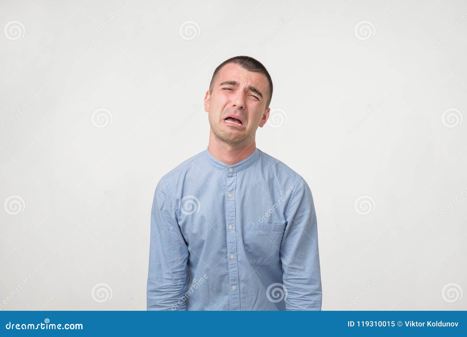 Studio Shot of Young Handsome Man, Pouting and Crying, Complaining ...