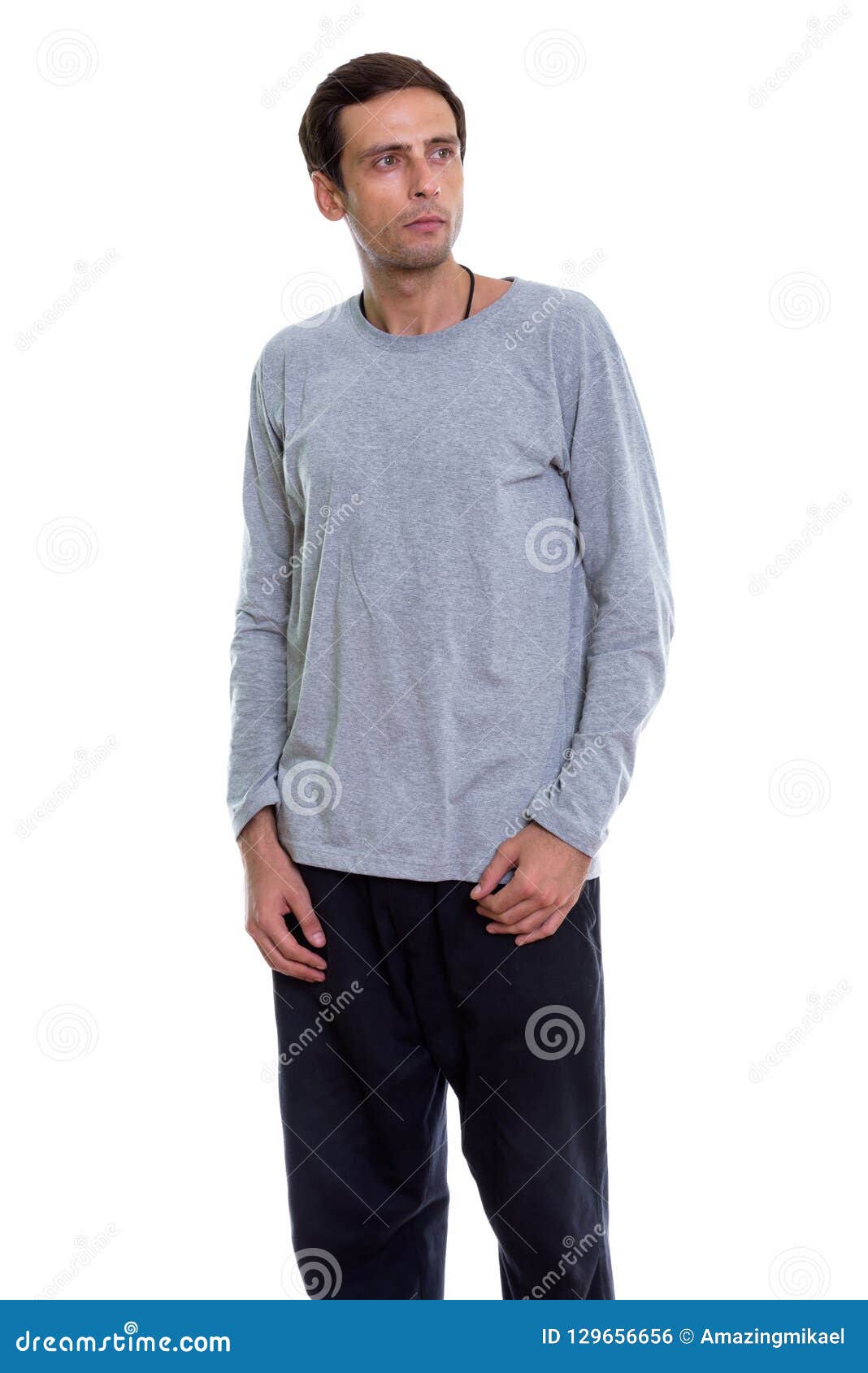 Studio Shot of Young Handsome Man Standing and Thinking while Lo Stock ...