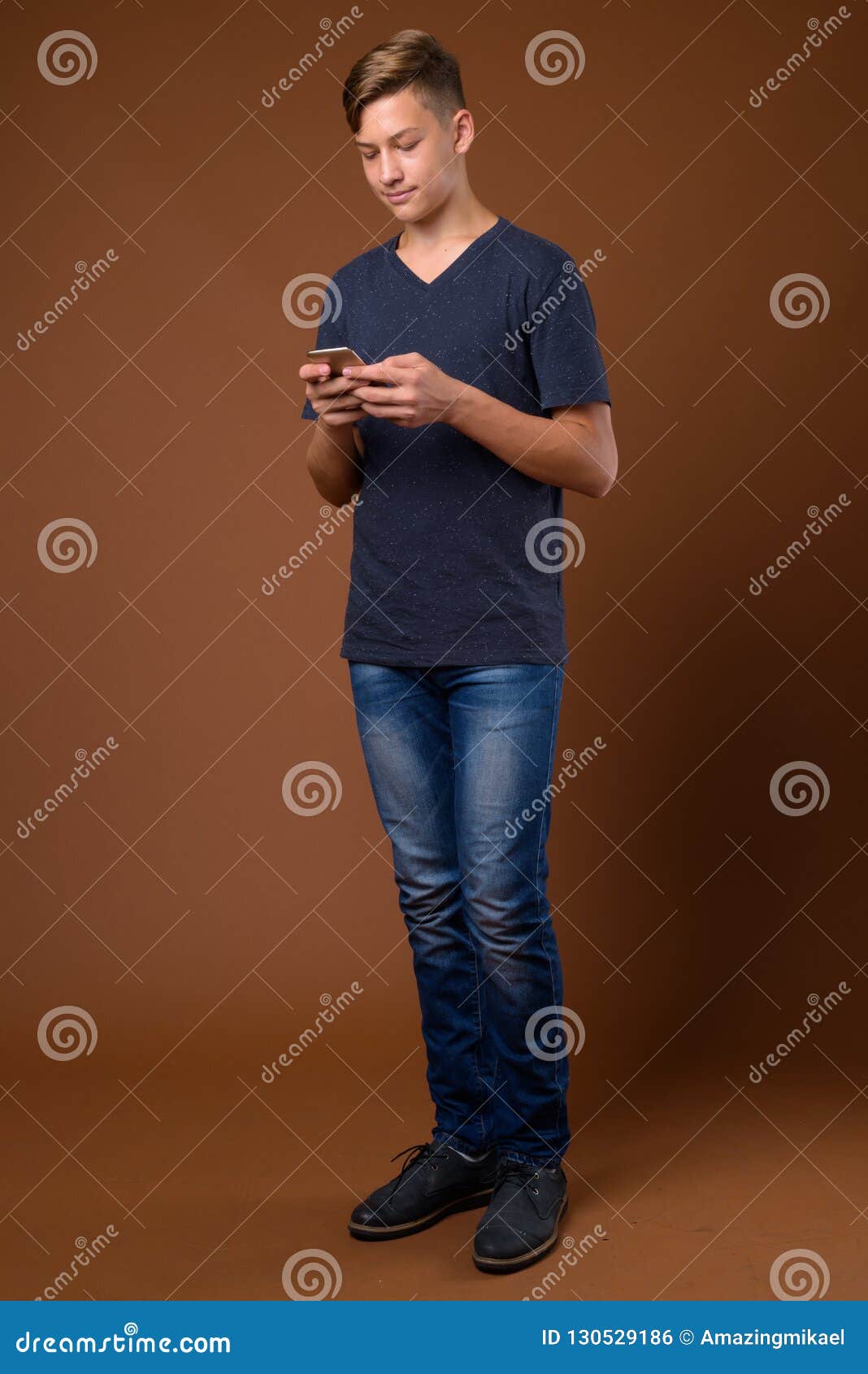 Studio Shot of Young Handsome Teenage Boy Against Brown Backgrou Stock ... Studio Shot of Young Handsome Teenage Boy Against Brown Backgrou Stock ...