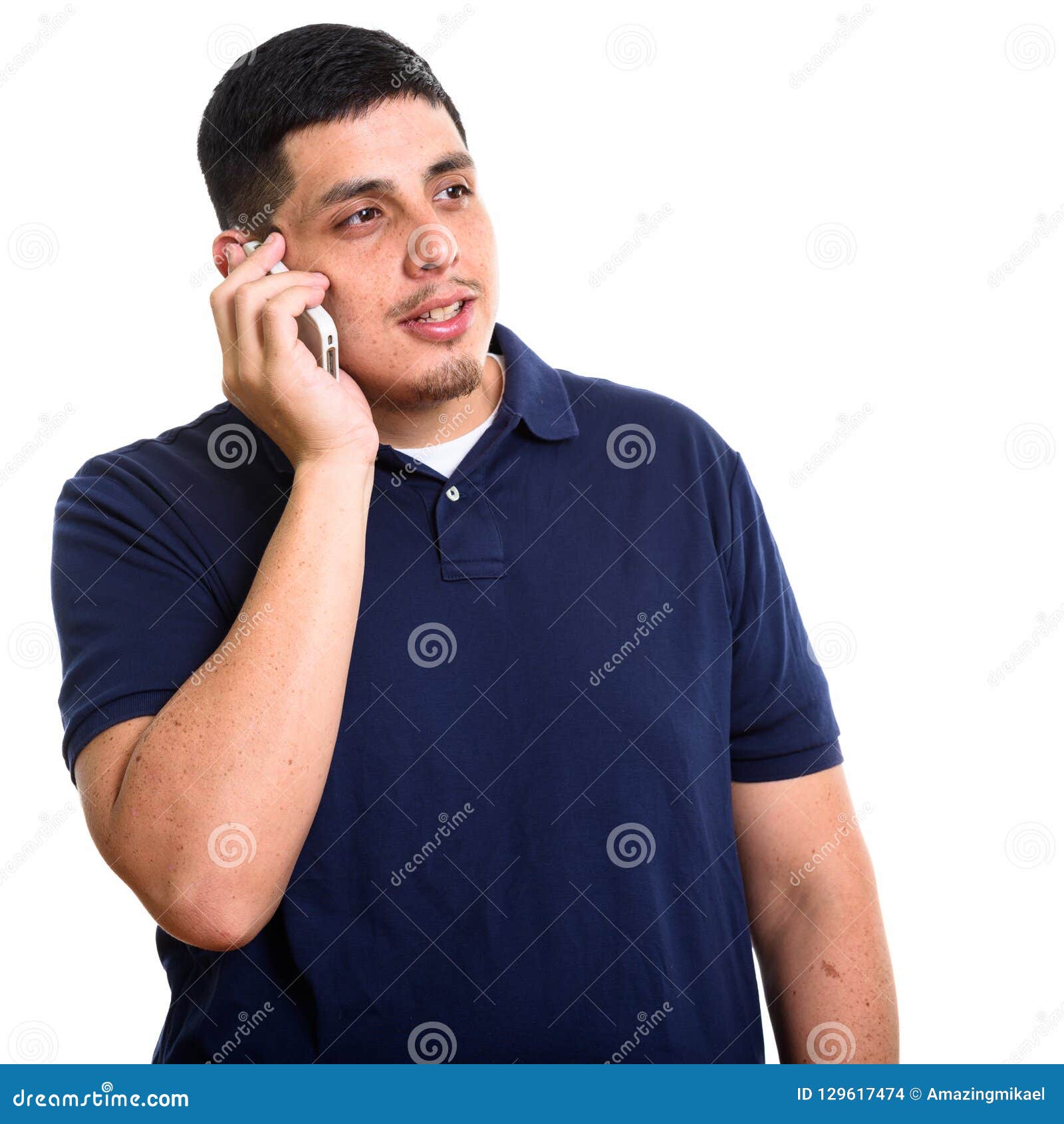Studio Shot of Young Hispanic Man Talking on Mobile Phone while Stock ...