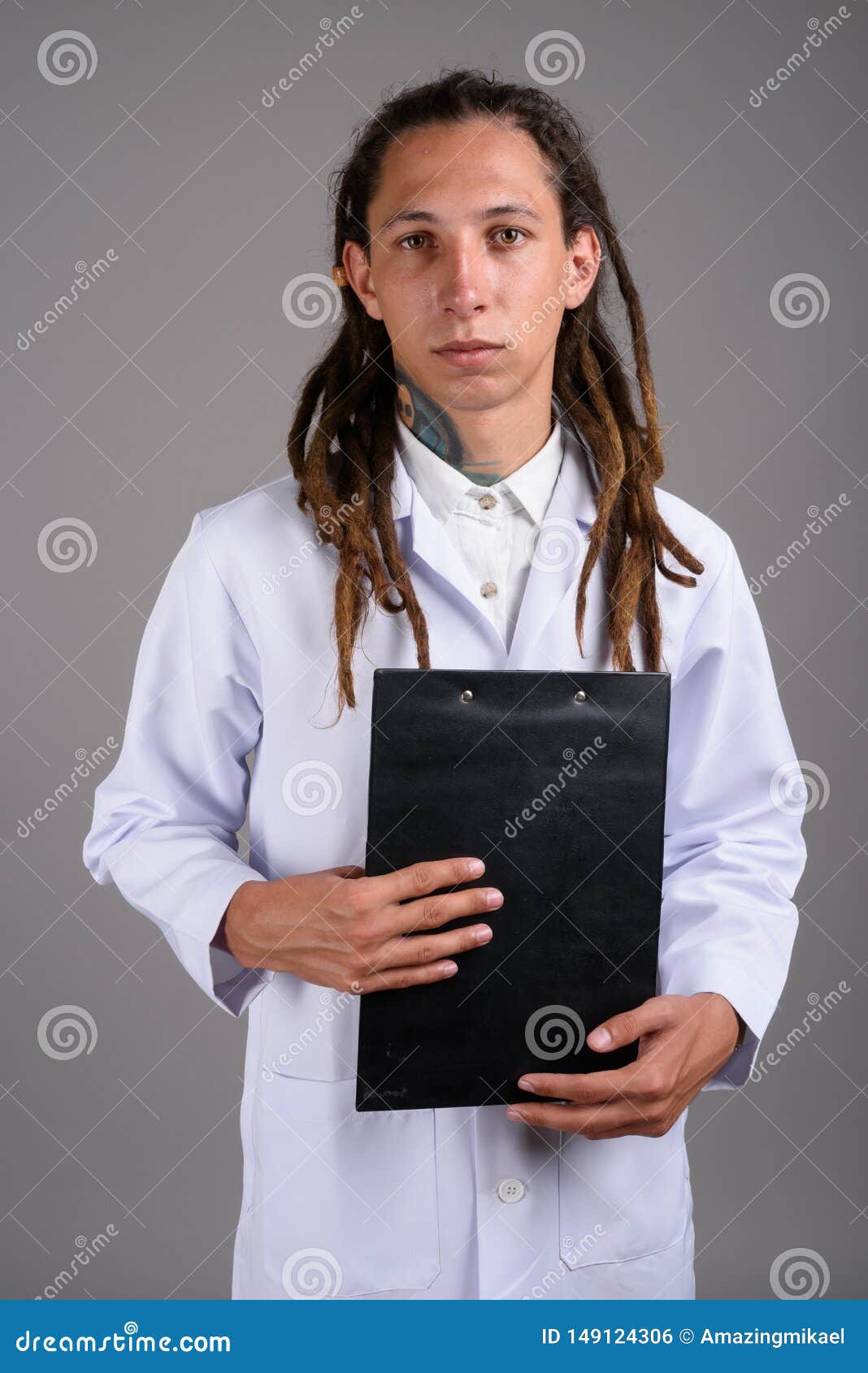 Young Man Doctor with Dreadlocks Against Gray Background Stock Photo ...