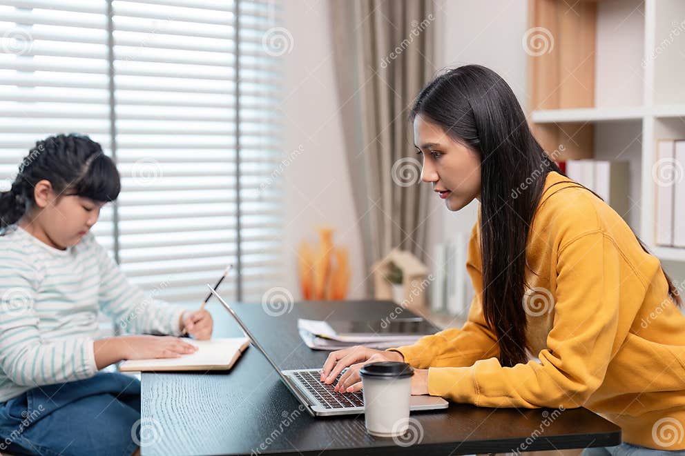 Studious Time Focused Mother and Daughter Engaged in Learning Stock ...