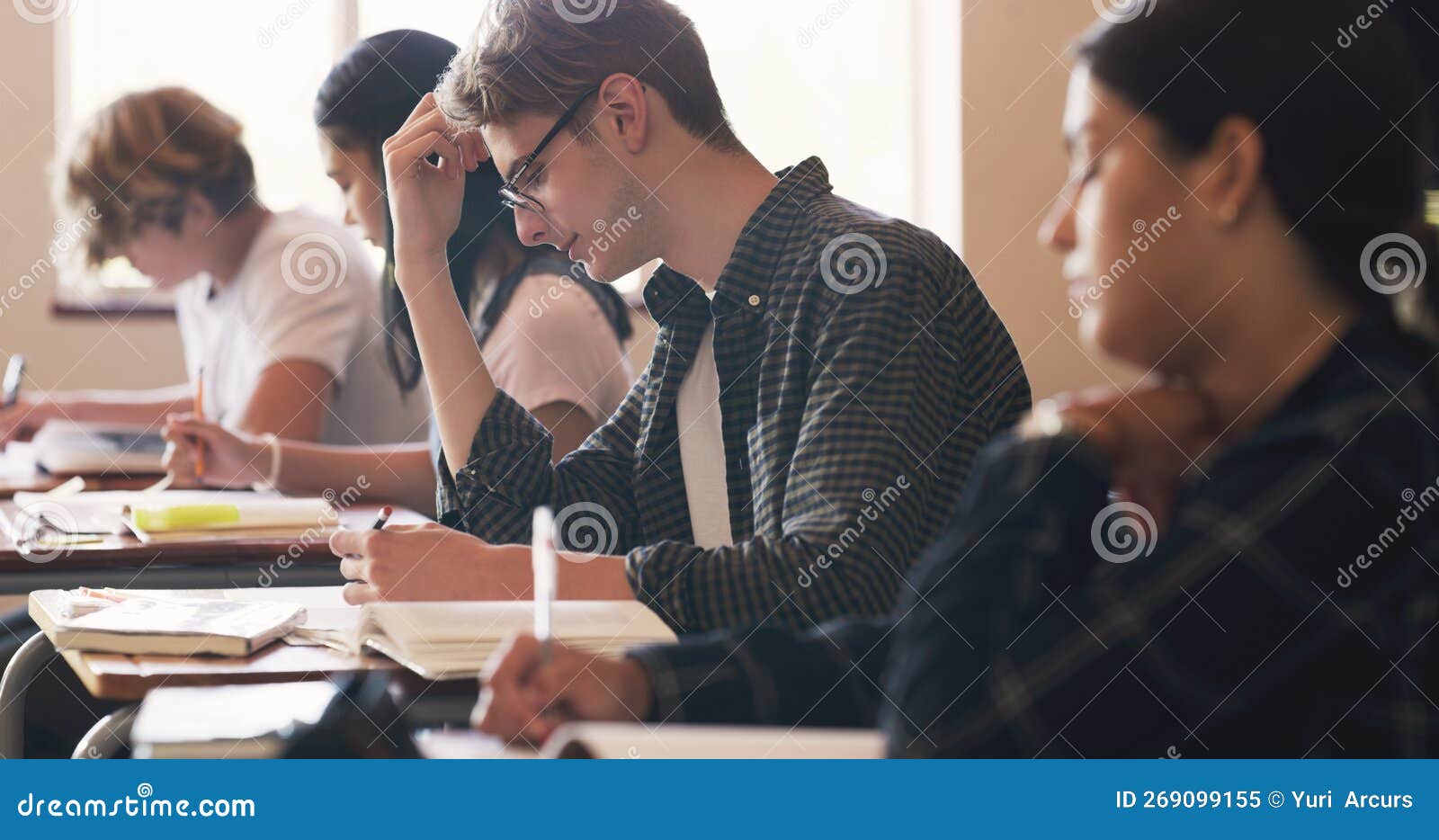 Study Hard, Make a Difference. Teenagers Writing an Exam in a Classroom ...