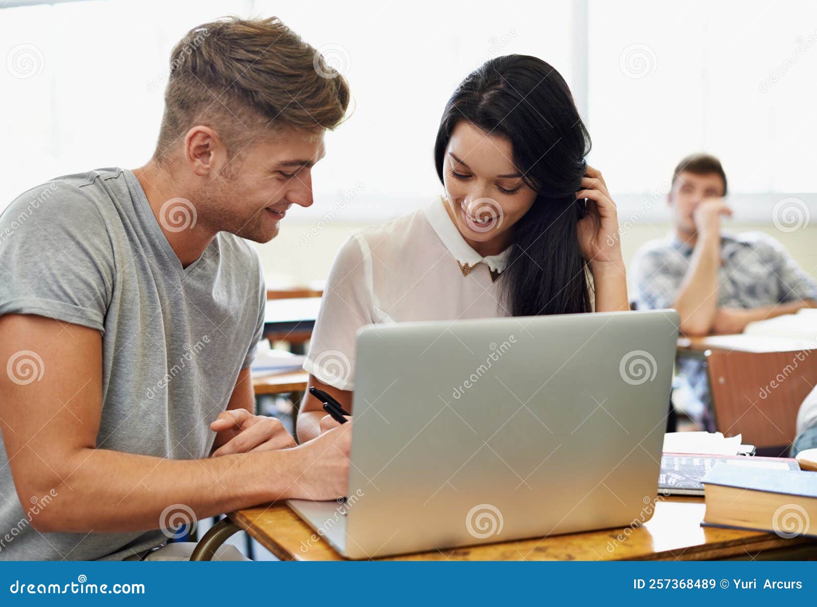 Study Partners. a Young Male and Female Student Studying in a Classroom ...