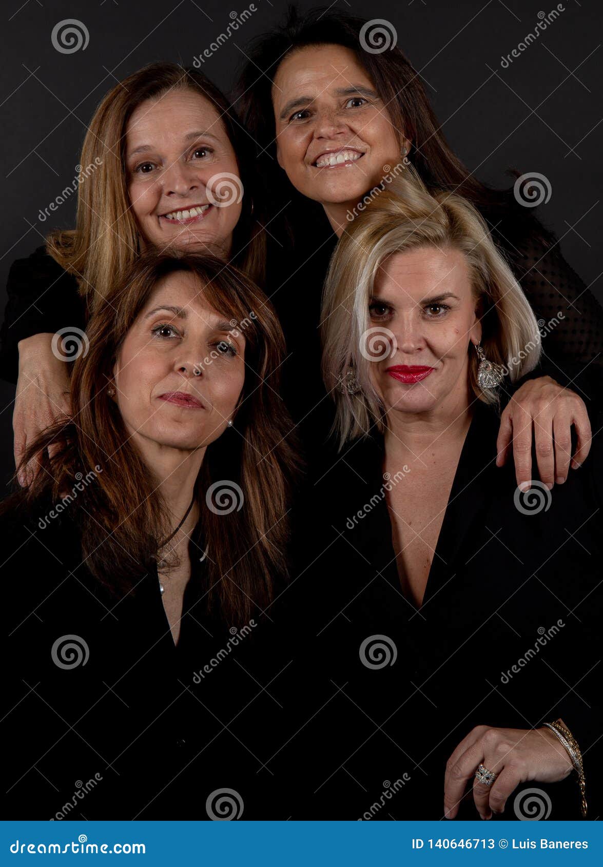Four Friends Posing in a Studio with a Black Background Stock Image ...