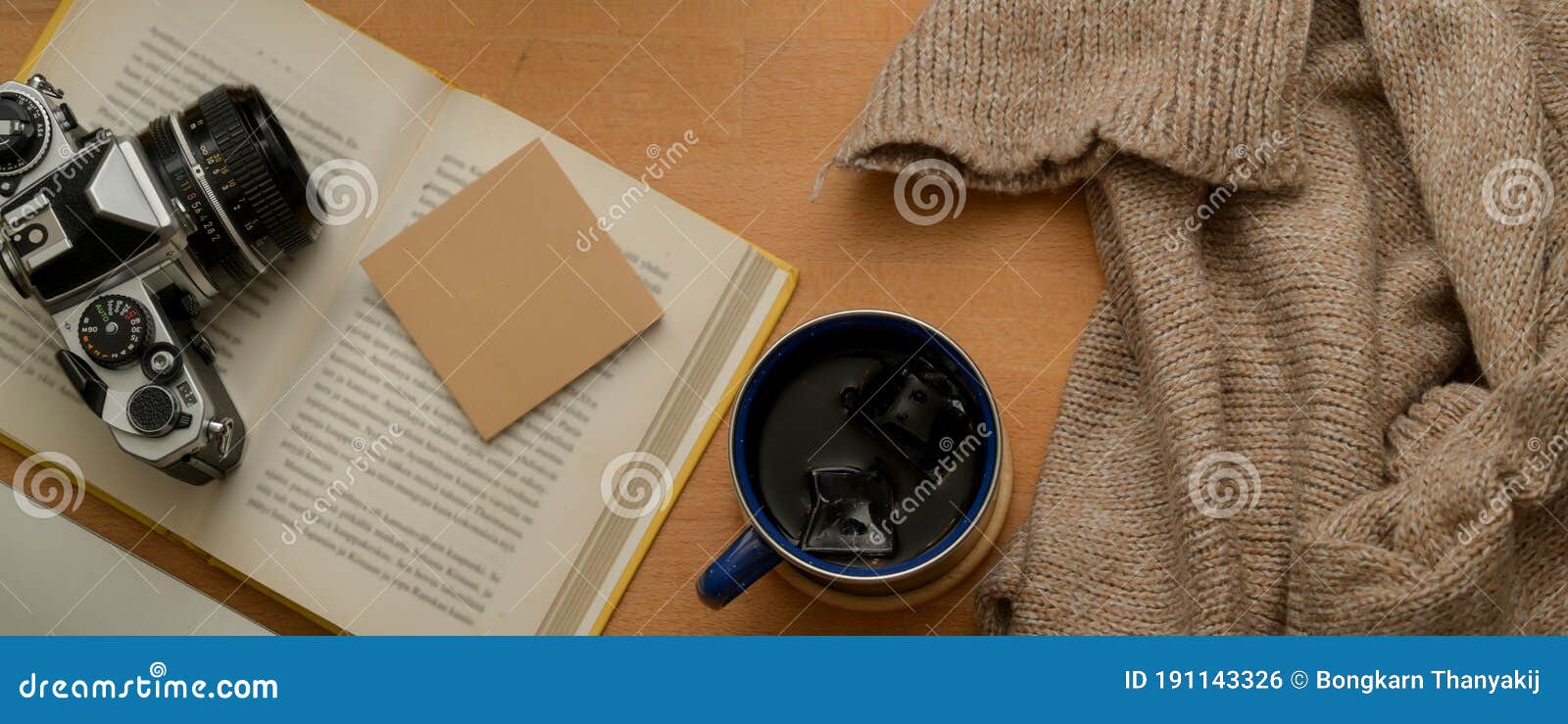 Study Table with Coffee Cup, Sweater, Opened Book, Notepad and Camera ...