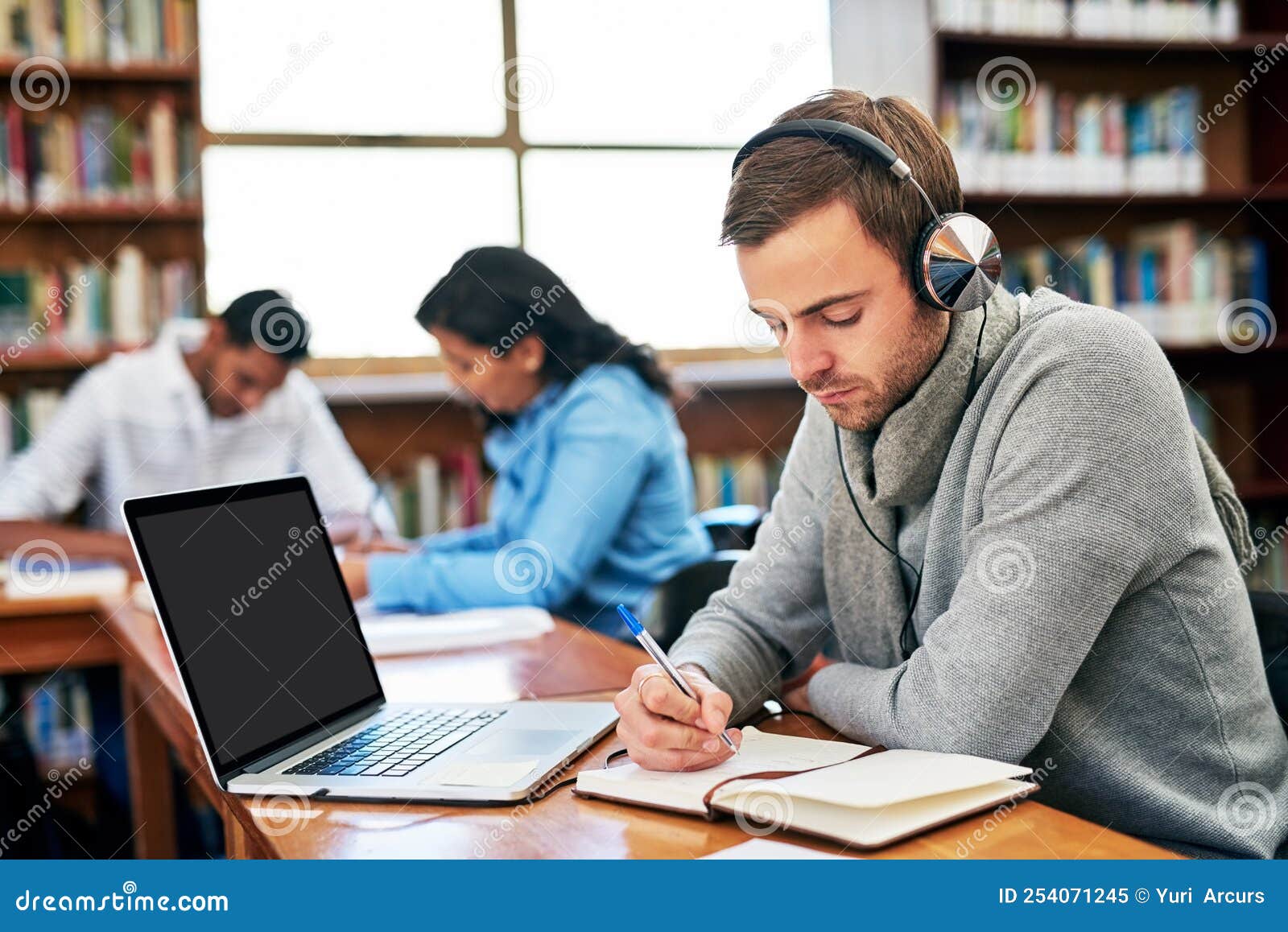 In the Study Zone. a University Student Working in the Library at ...