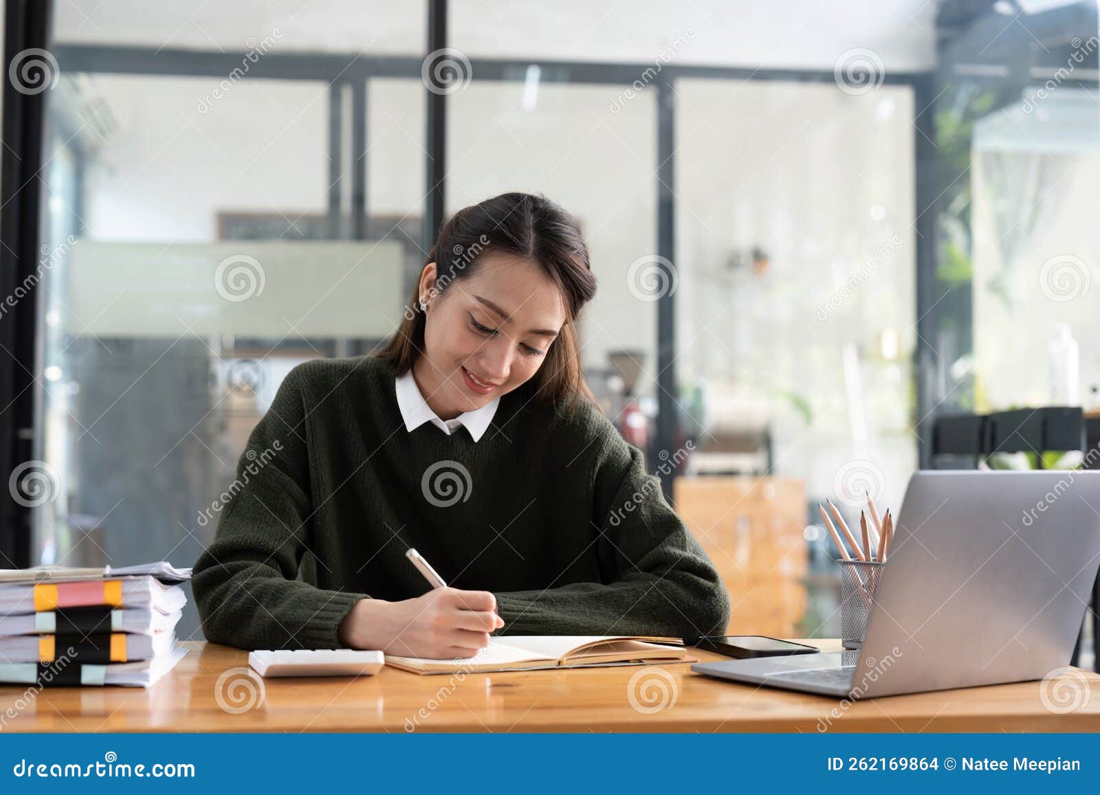 Studying Remotely from Home, Using a Laptop, Taking Notes on Notepad ...