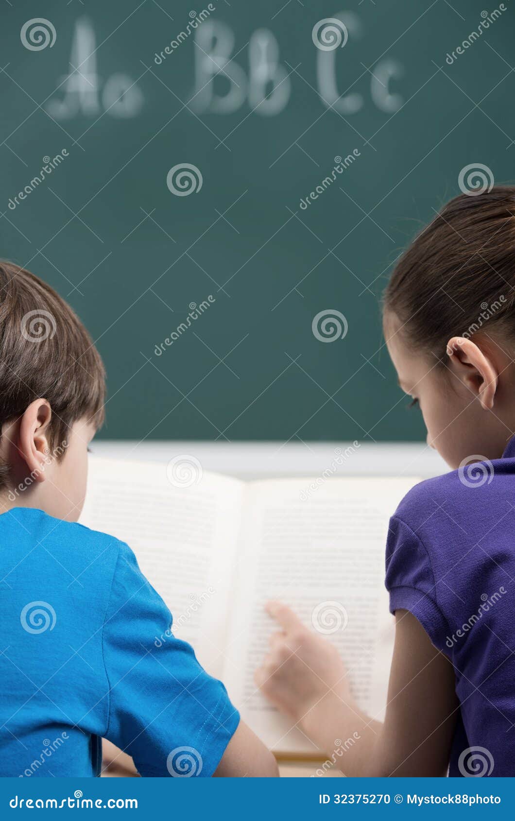 Studying Together. Rear View of Two Little Classmates Reading a Stock ...