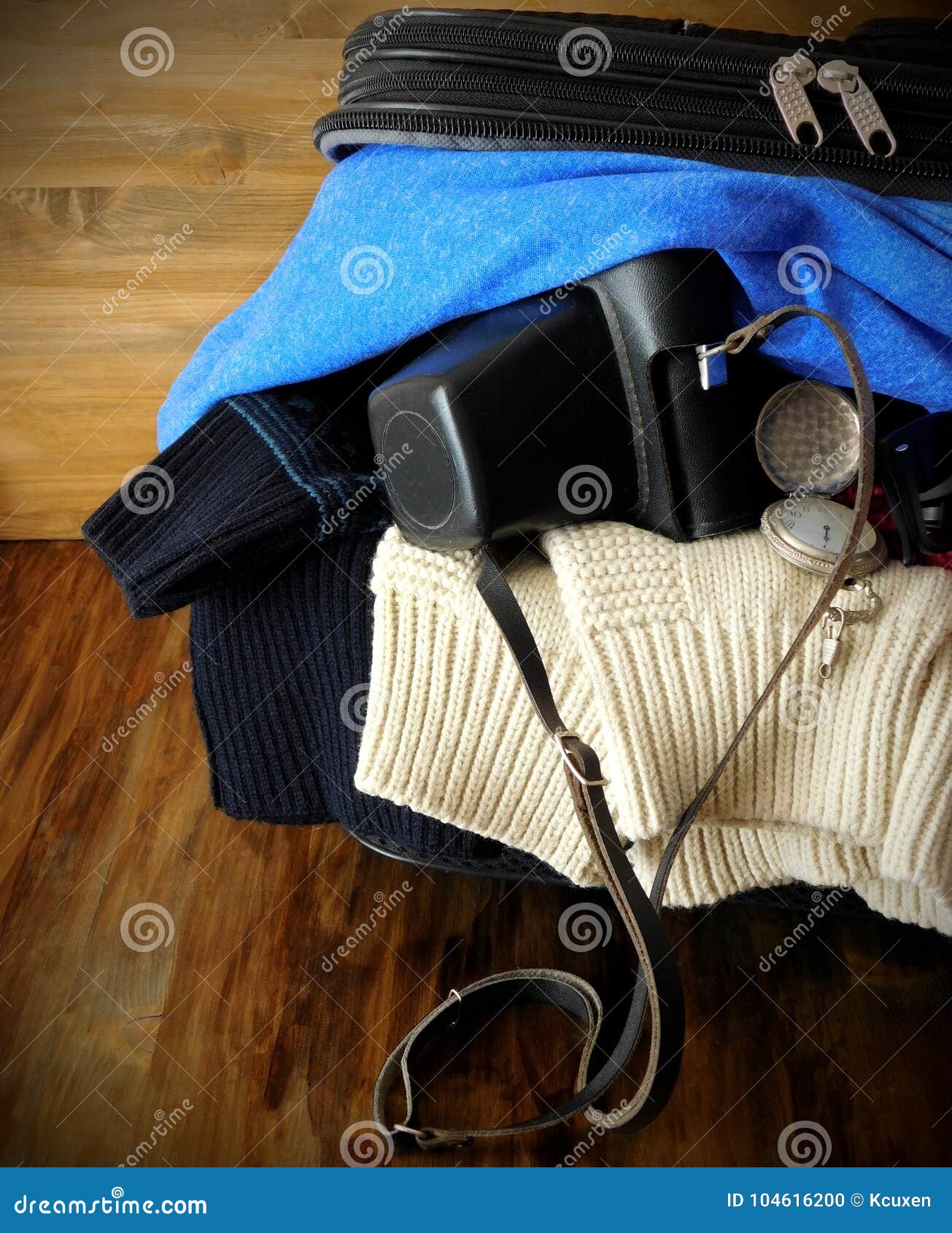 A Stuffed Suitcase with Clothes and an Old Camera is Ready for a Trip ...