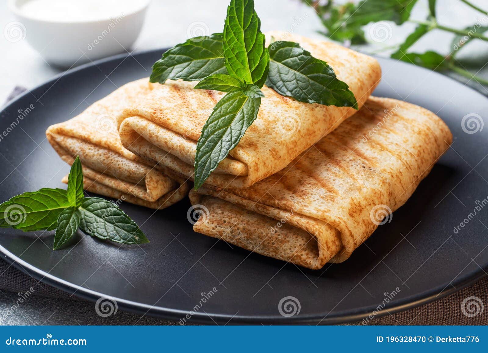 Stuffed Thin Pancakes Rolled into Rolls are Grilled on a Black Plate ...
